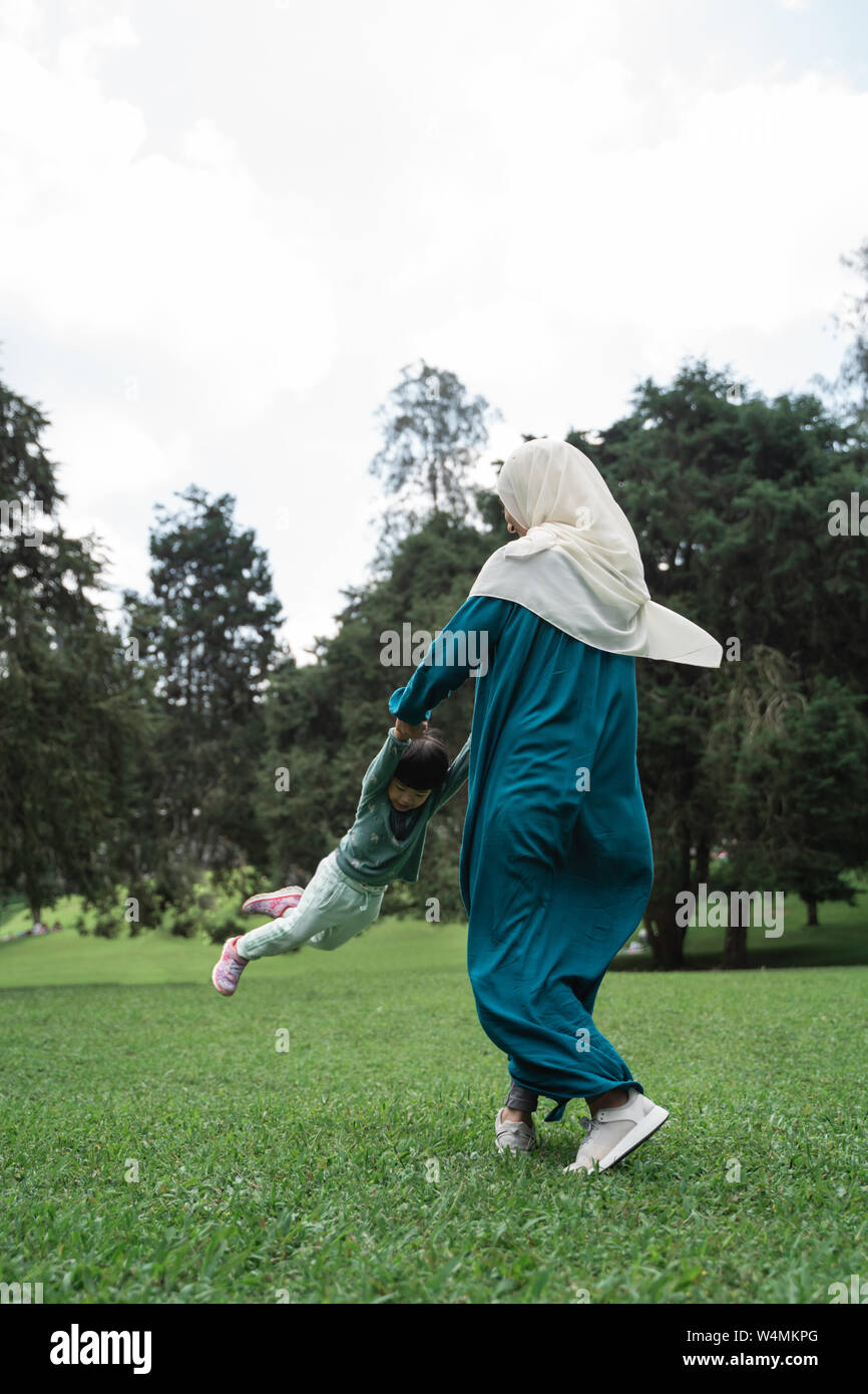 little girl playing spin around with mother Stock Photo - Alamy