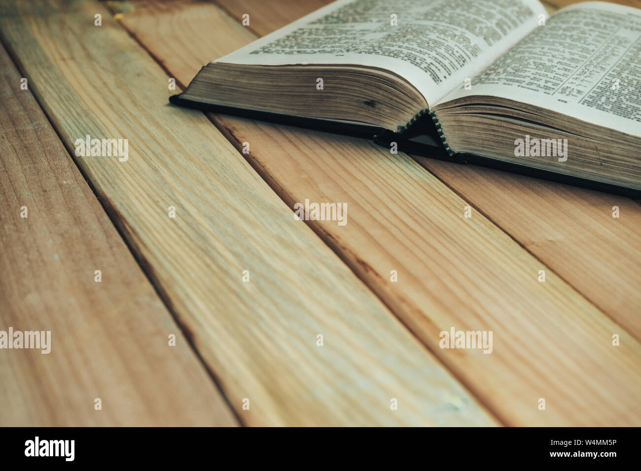 Close up open Bible book on a wooden table background Stock Photo - Alamy