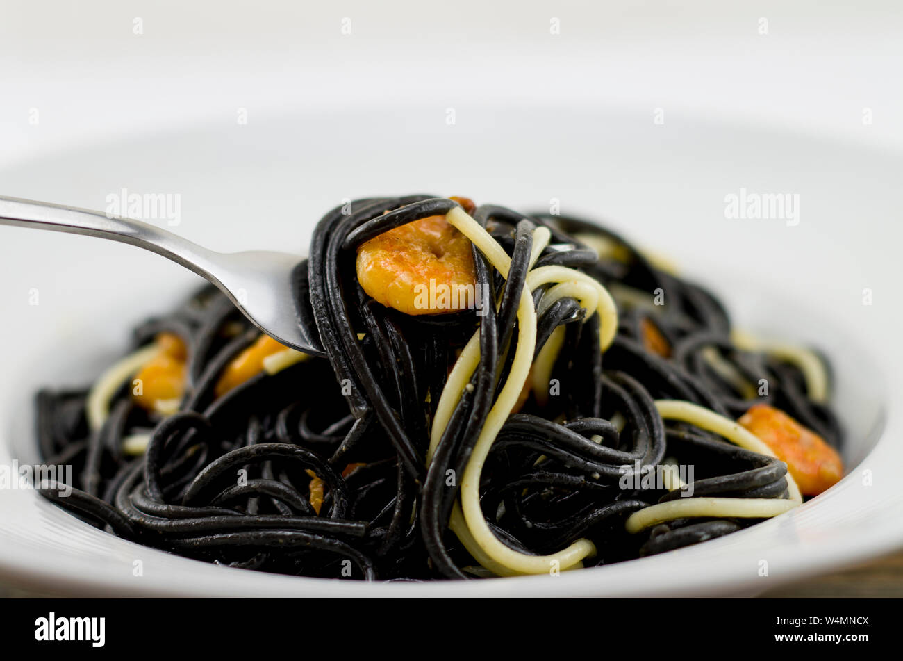 Italian black spaghetti, alla Veneziana, with grilled prawns and dried ...