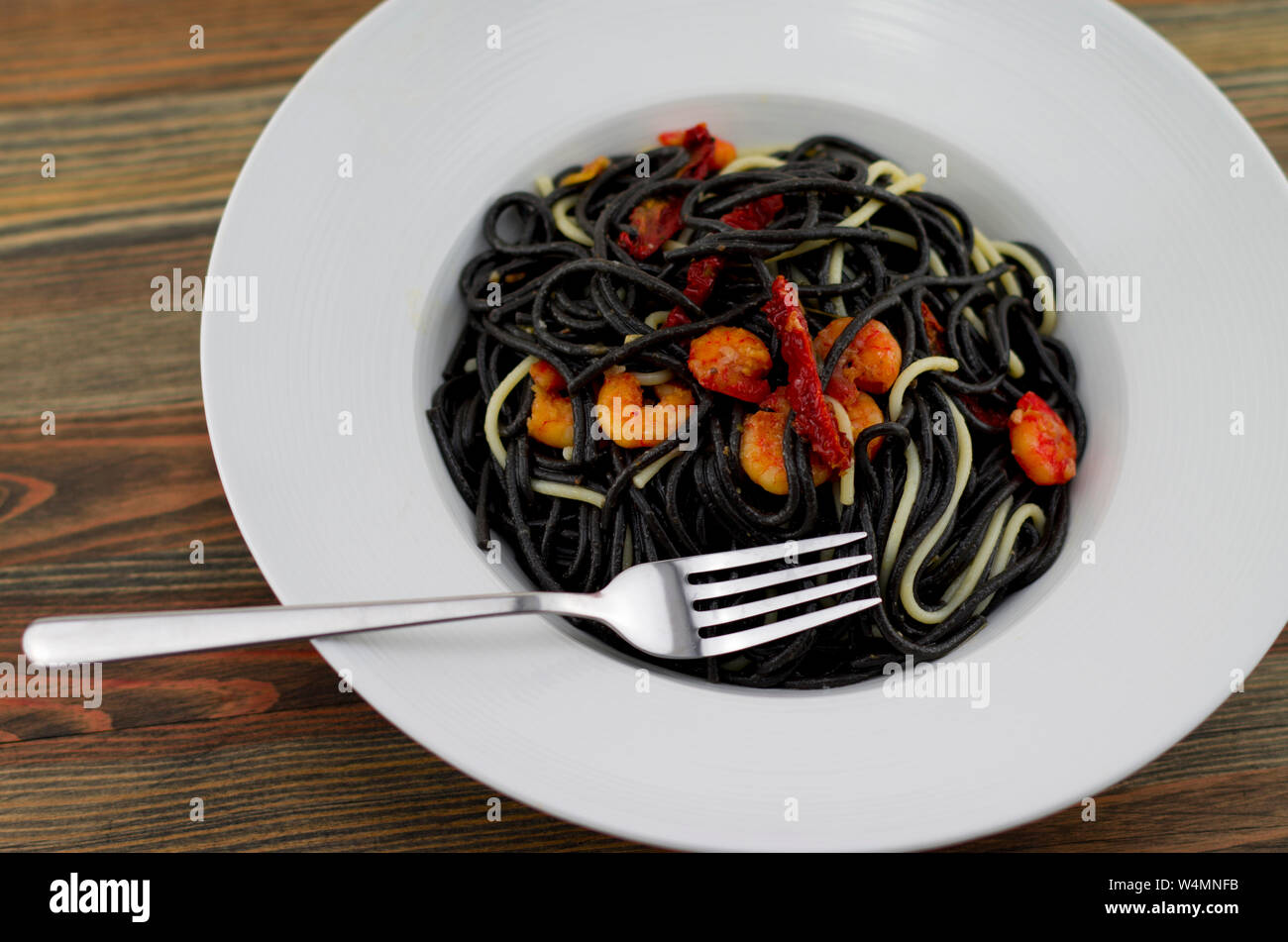 Italian black spaghetti, alla Veneziana, with grilled prawns and dried ...