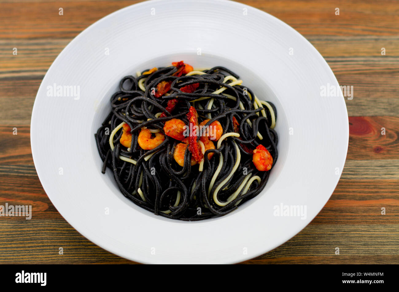 Italian black spaghetti, alla Veneziana, with grilled prawns and dried ...