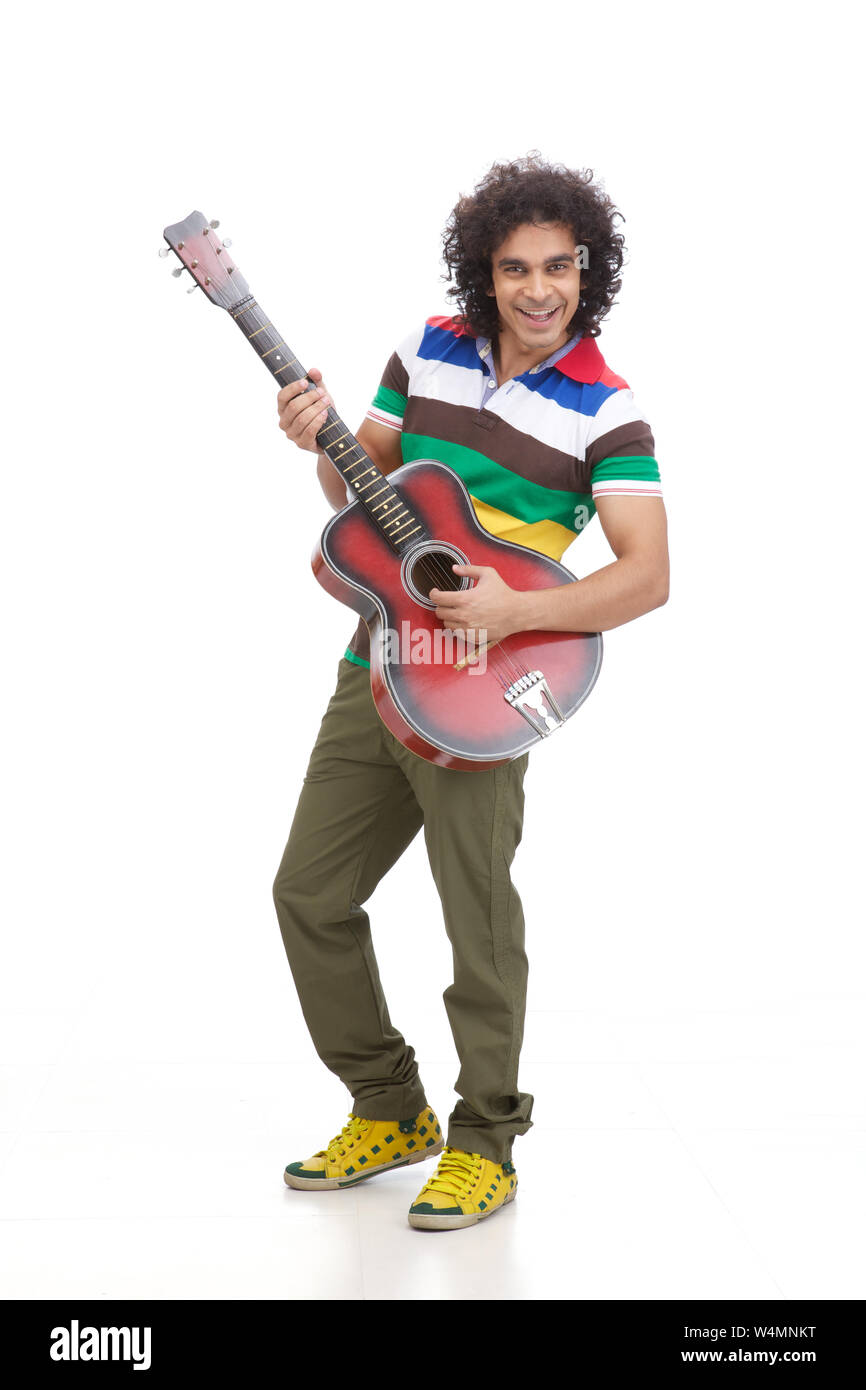 Man playing a guitar and smiling Stock Photo - Alamy
