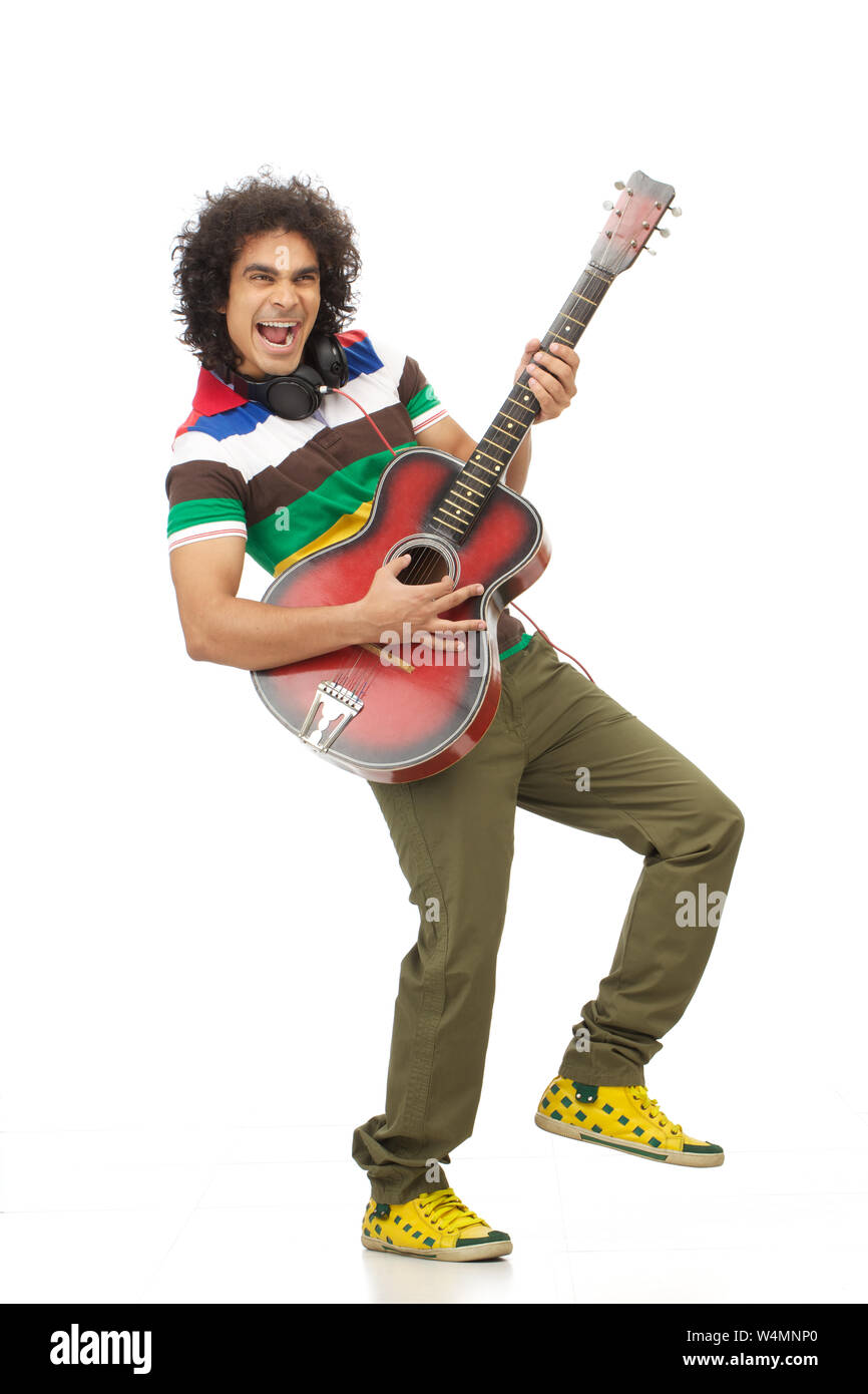 Man playing a guitar and smiling Stock Photo - Alamy