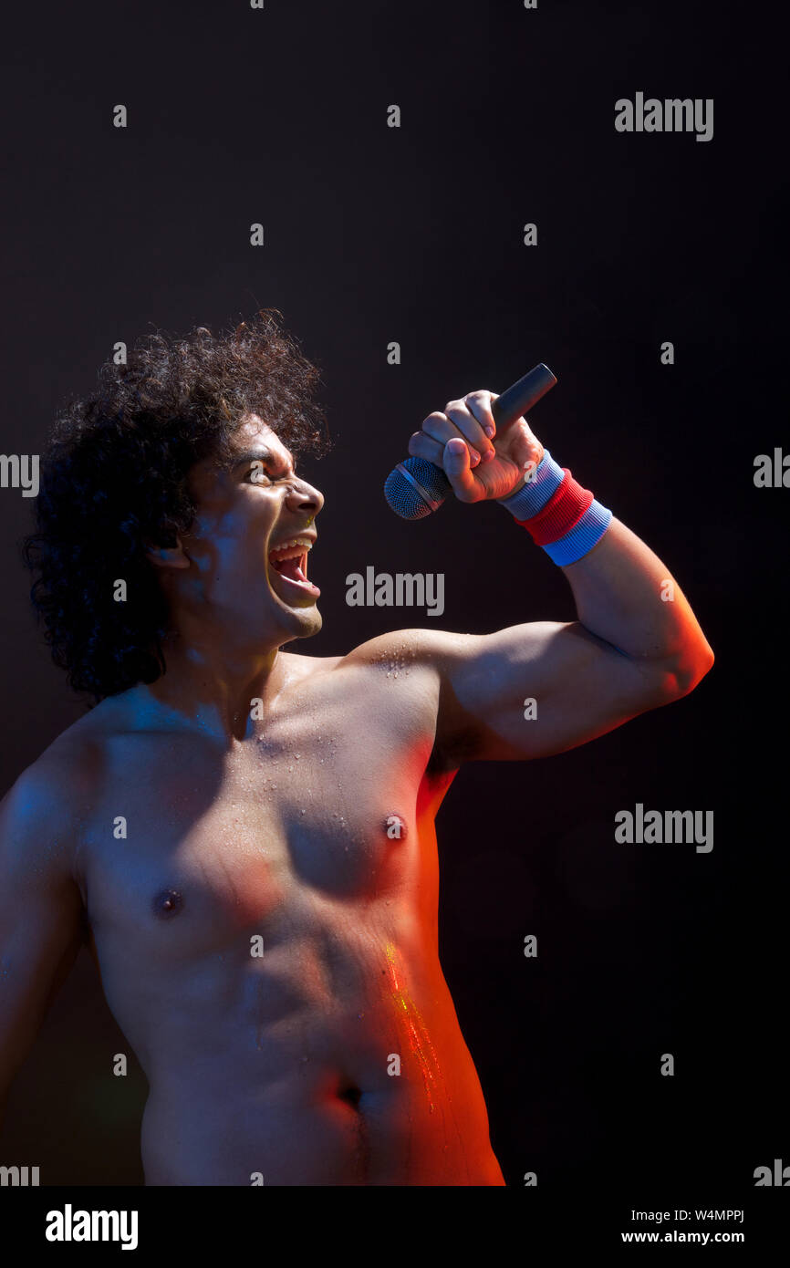 Man singing into microphone Stock Photo - Alamy