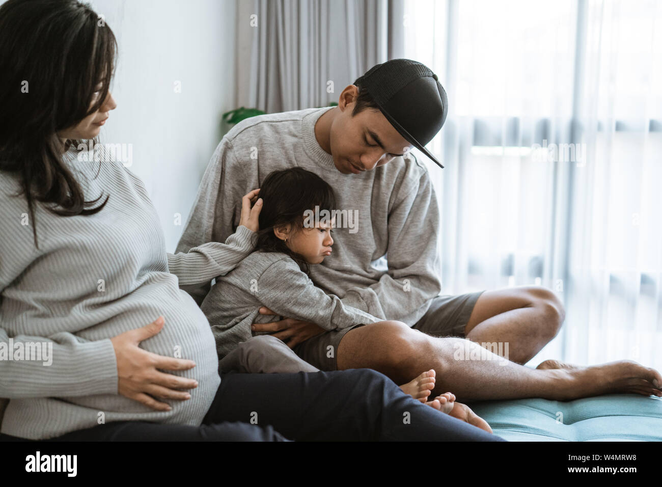 sadness of little girl with mother and embrace father Stock Photo - Alamy