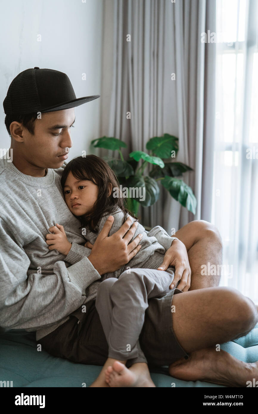 sad little girl resting on her father's chest Stock Photo - Alamy