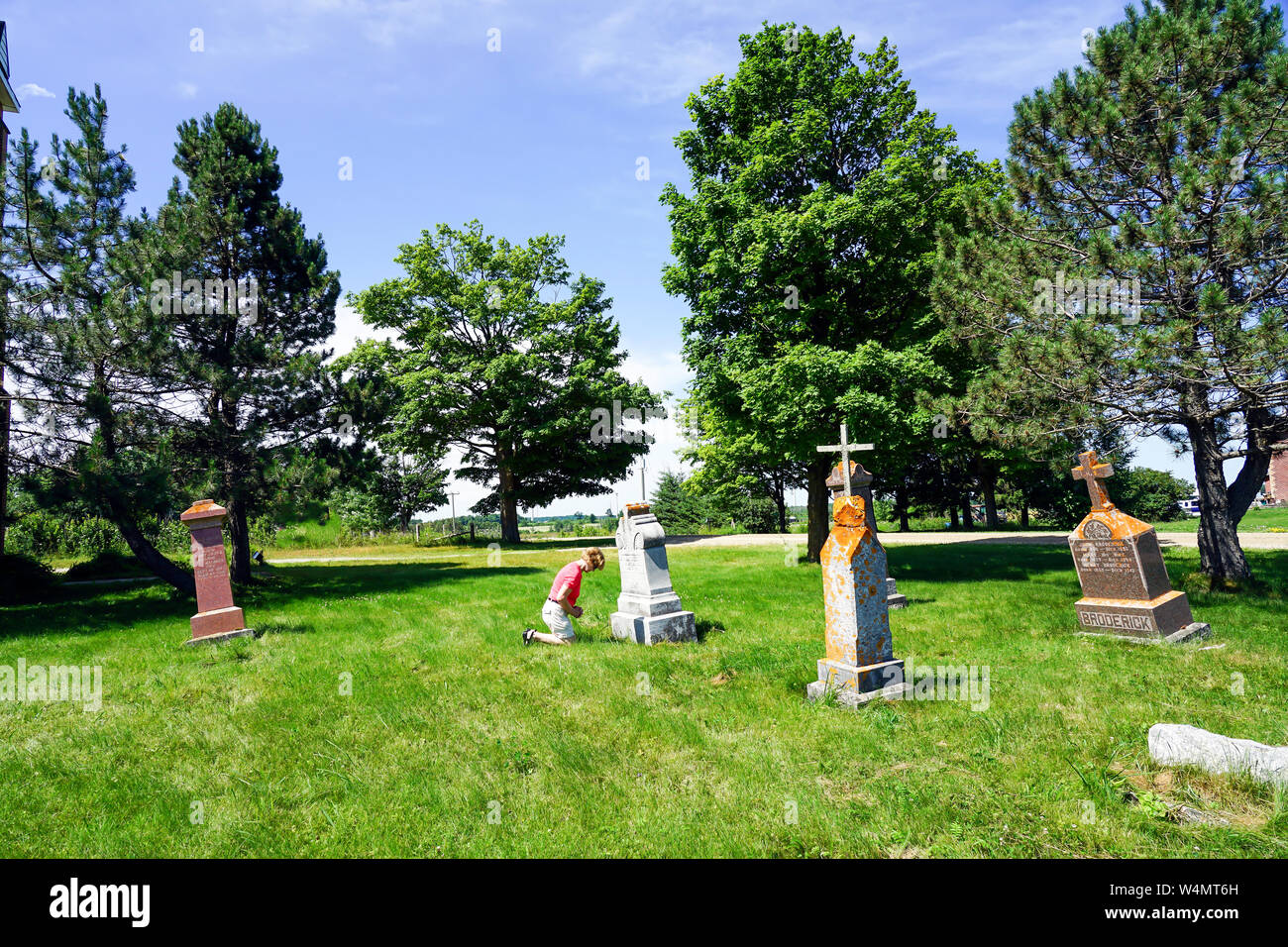 Woman on knees grass field hi-res stock photography and images - Alamy
