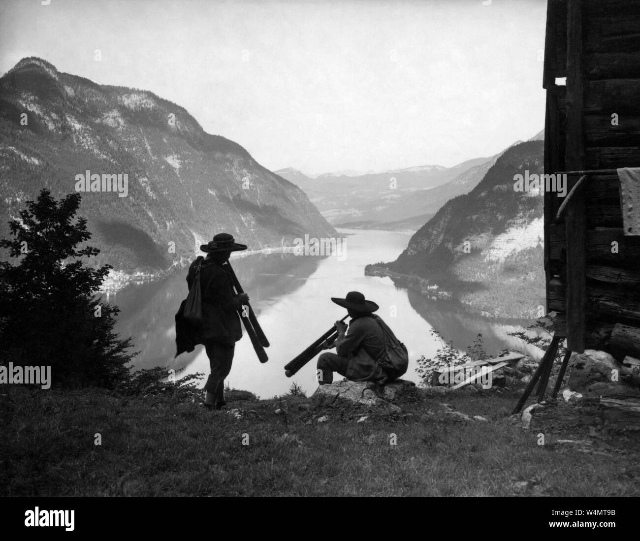two shepherds with old musical instruments made from roots, lake ...