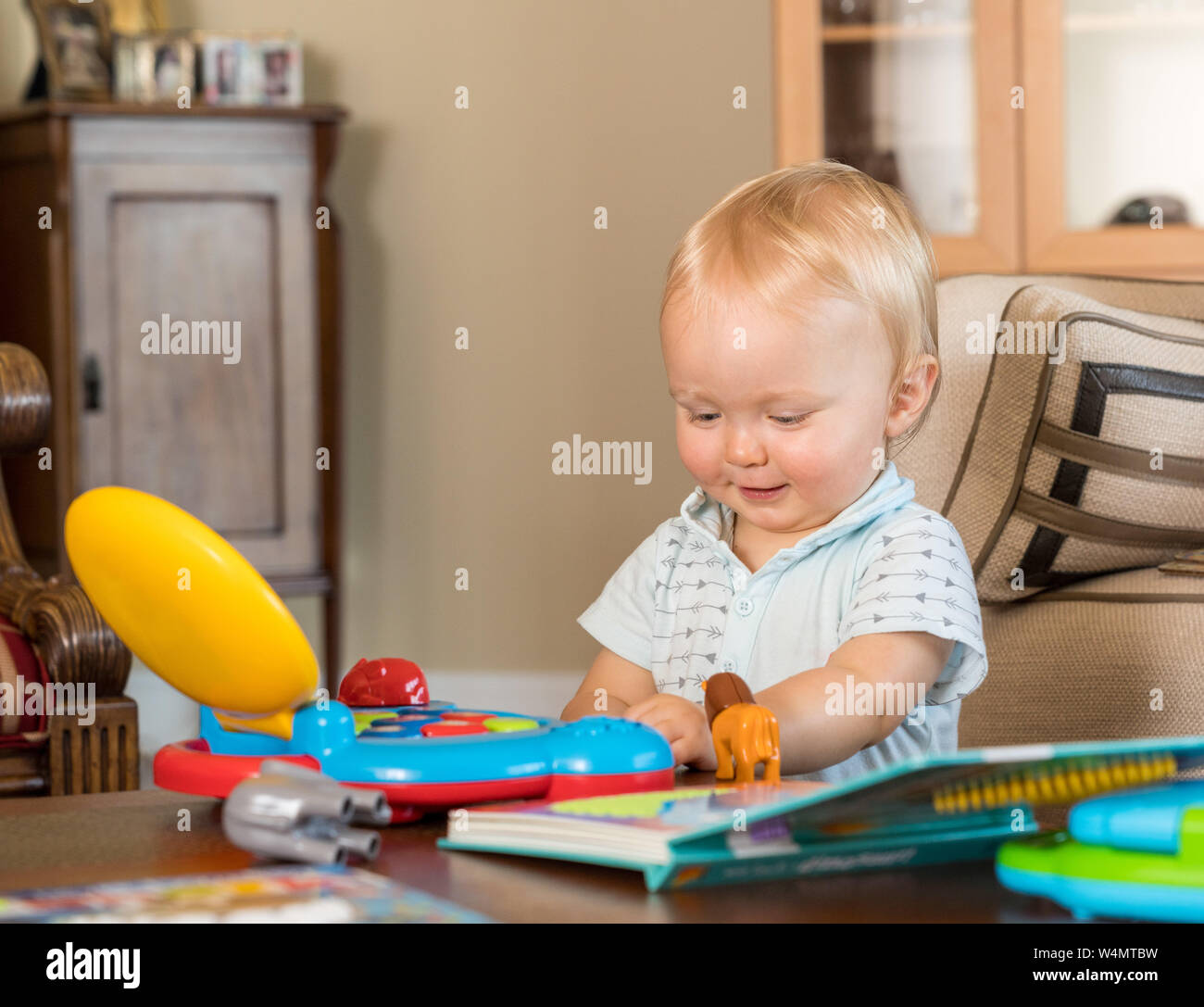 Infant caucasian boy playing with toy computer Stock Photo - Alamy
