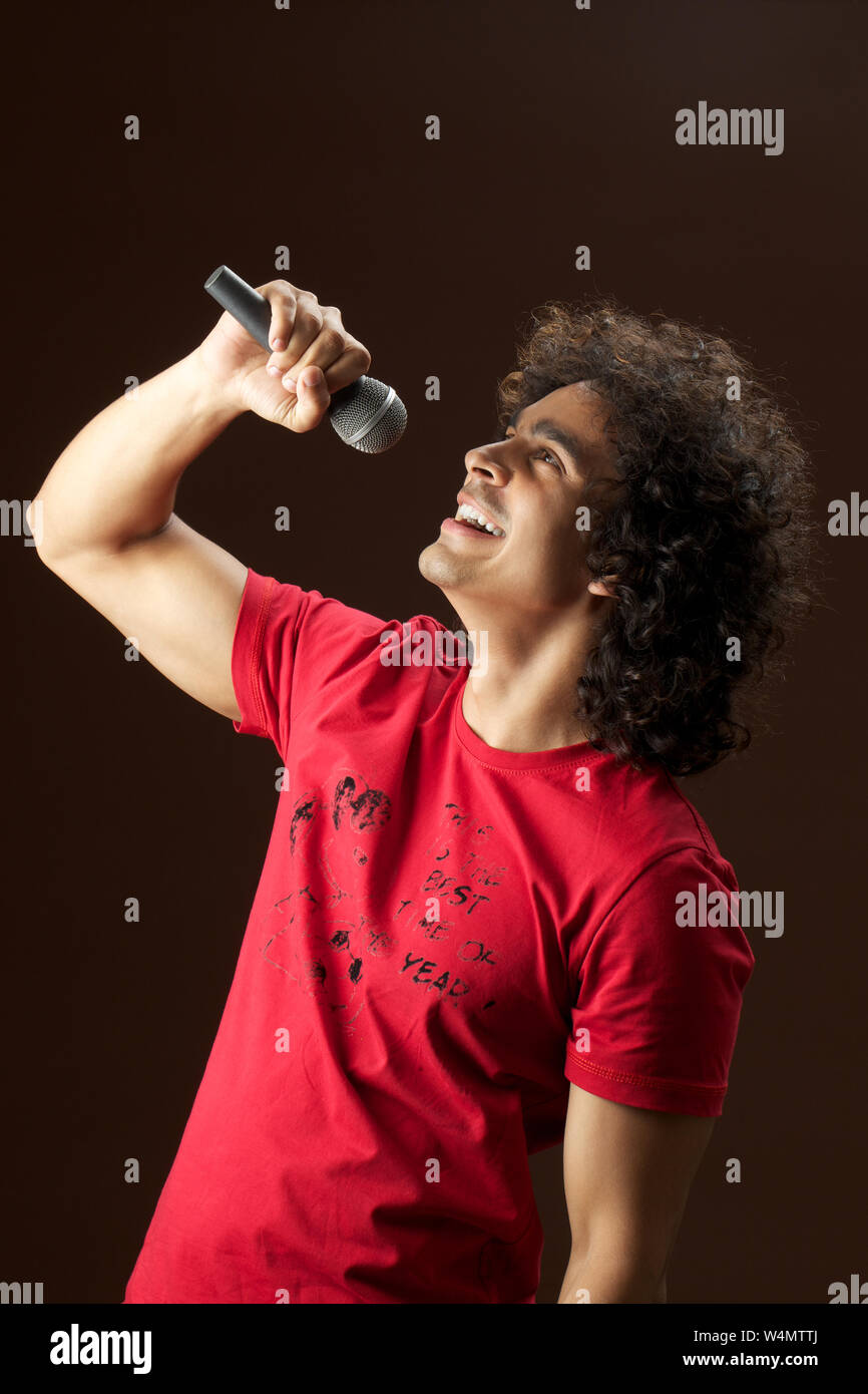 Indian man singing microphone smiling hi-res stock photography and ...
