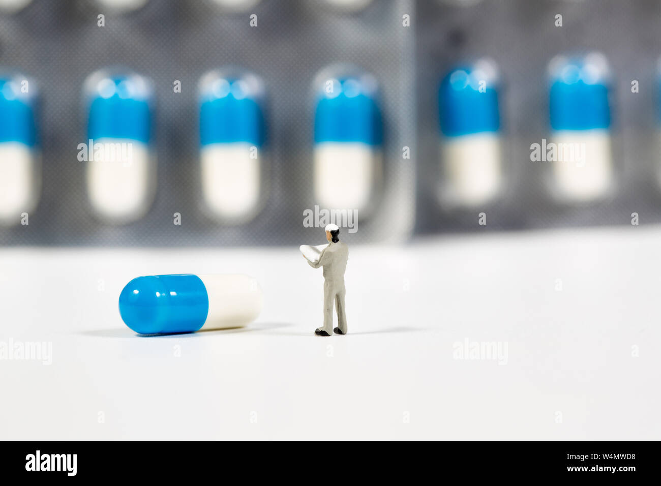 miniature people on the drugs or pils on white,medical concept Stock ...