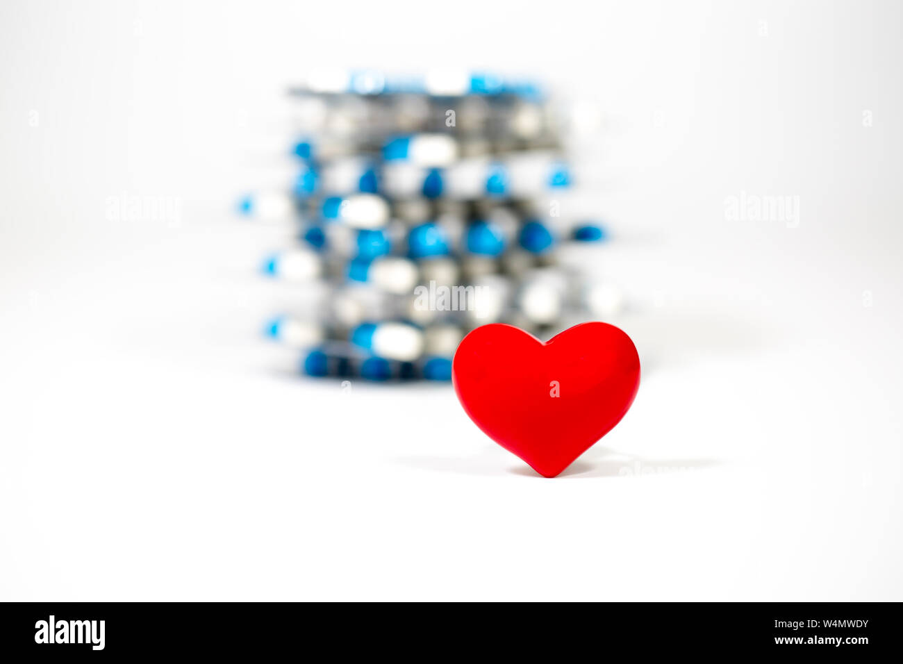 red heart with medical drug background Stock Photo - Alamy