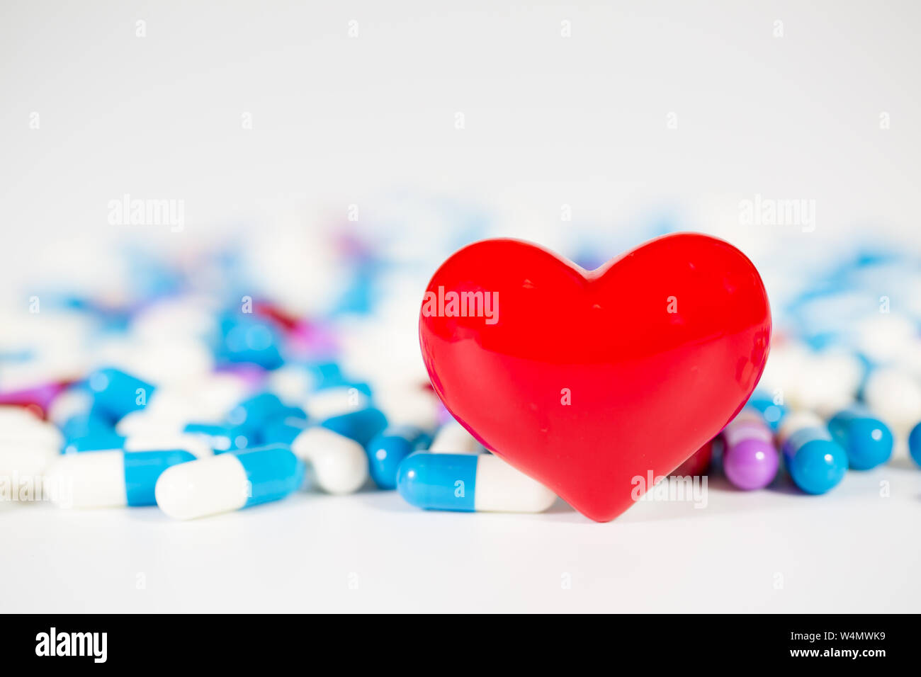 red heart with medical drug background Stock Photo - Alamy