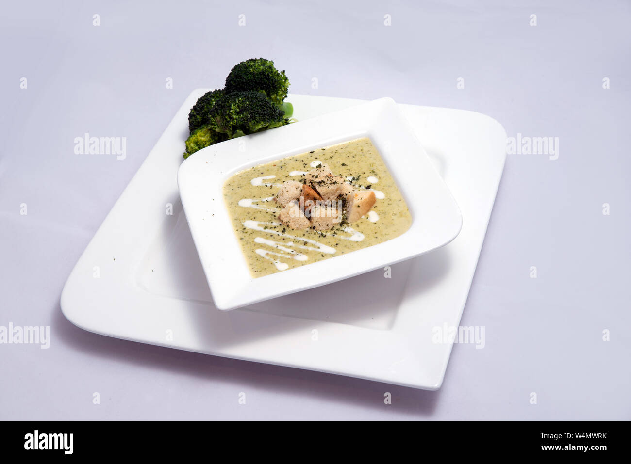 Hero Shot of a Broccoli Soup with bread crumbs, oregano on a minimal ...