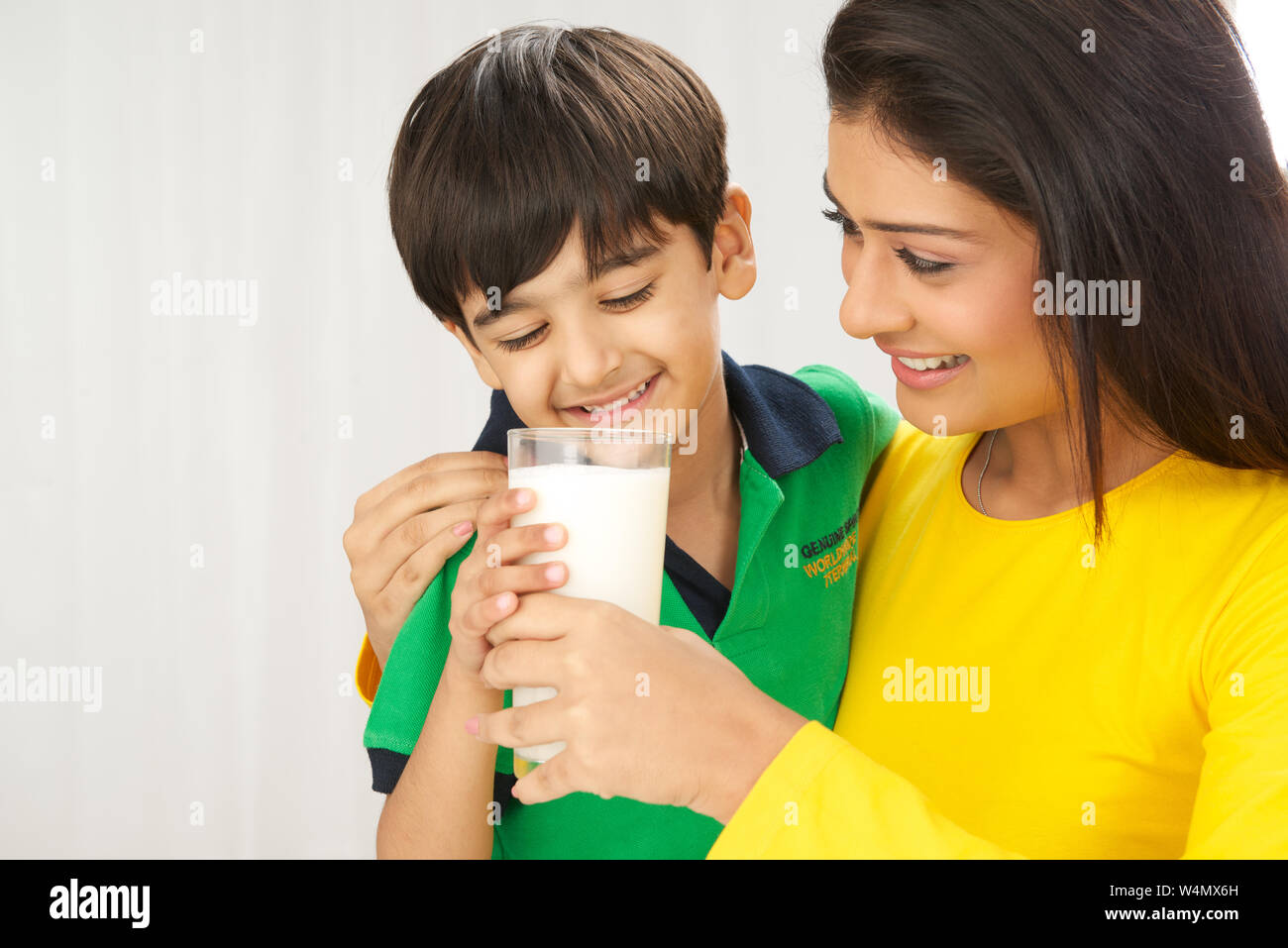 Woman giving milk to her son Stock Photo - Alamy