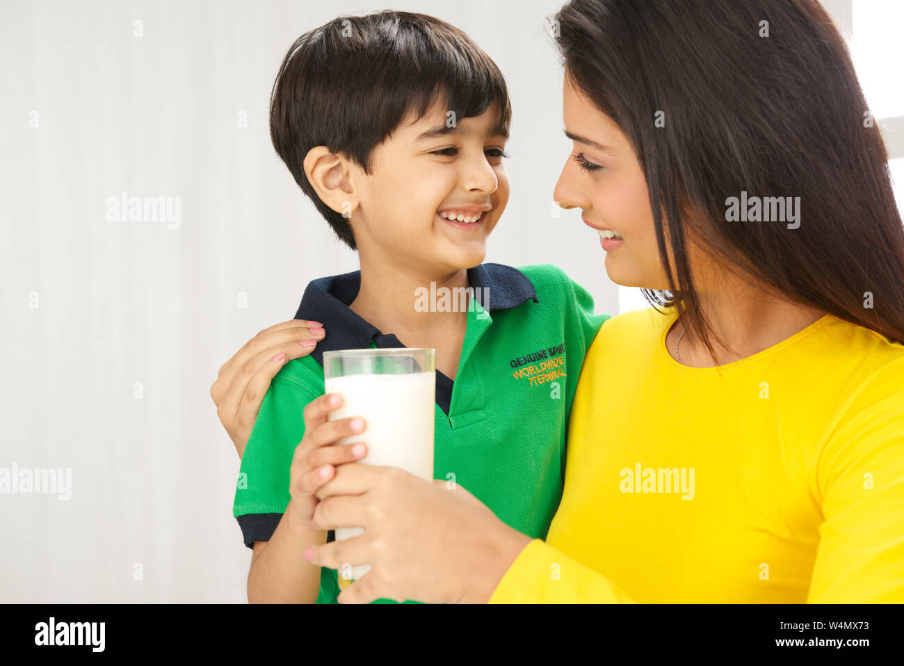 Woman giving milk to her son Stock Photo - Alamy