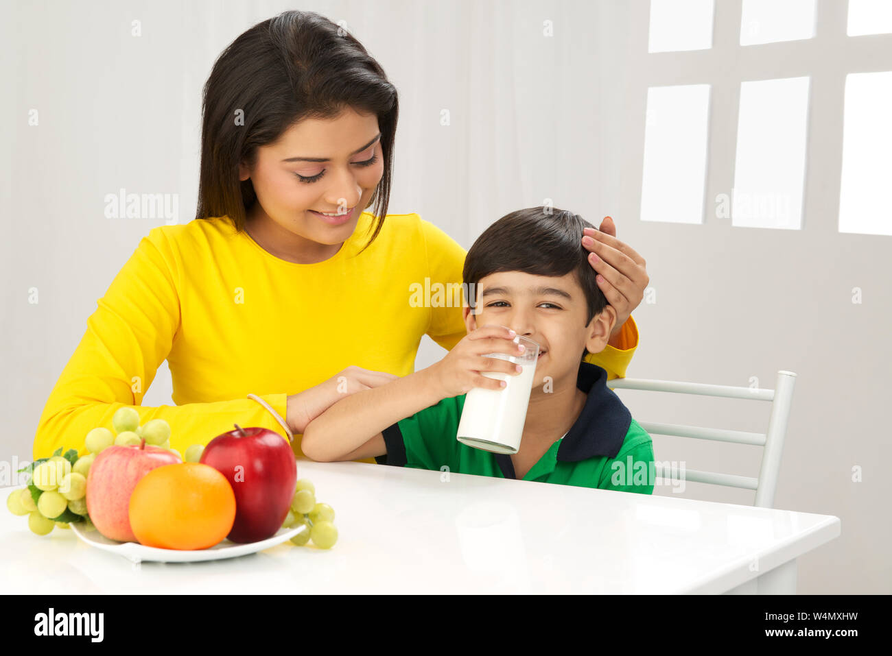 Boy having milk with his mother Stock Photo - Alamy