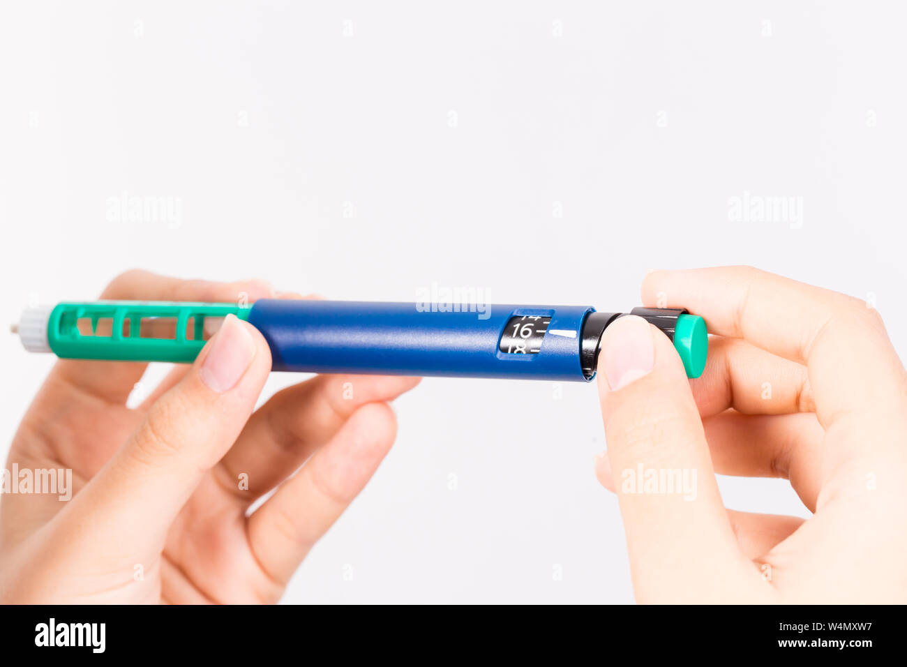 hand holding in sulin pen on white background Stock Photo - Alamy