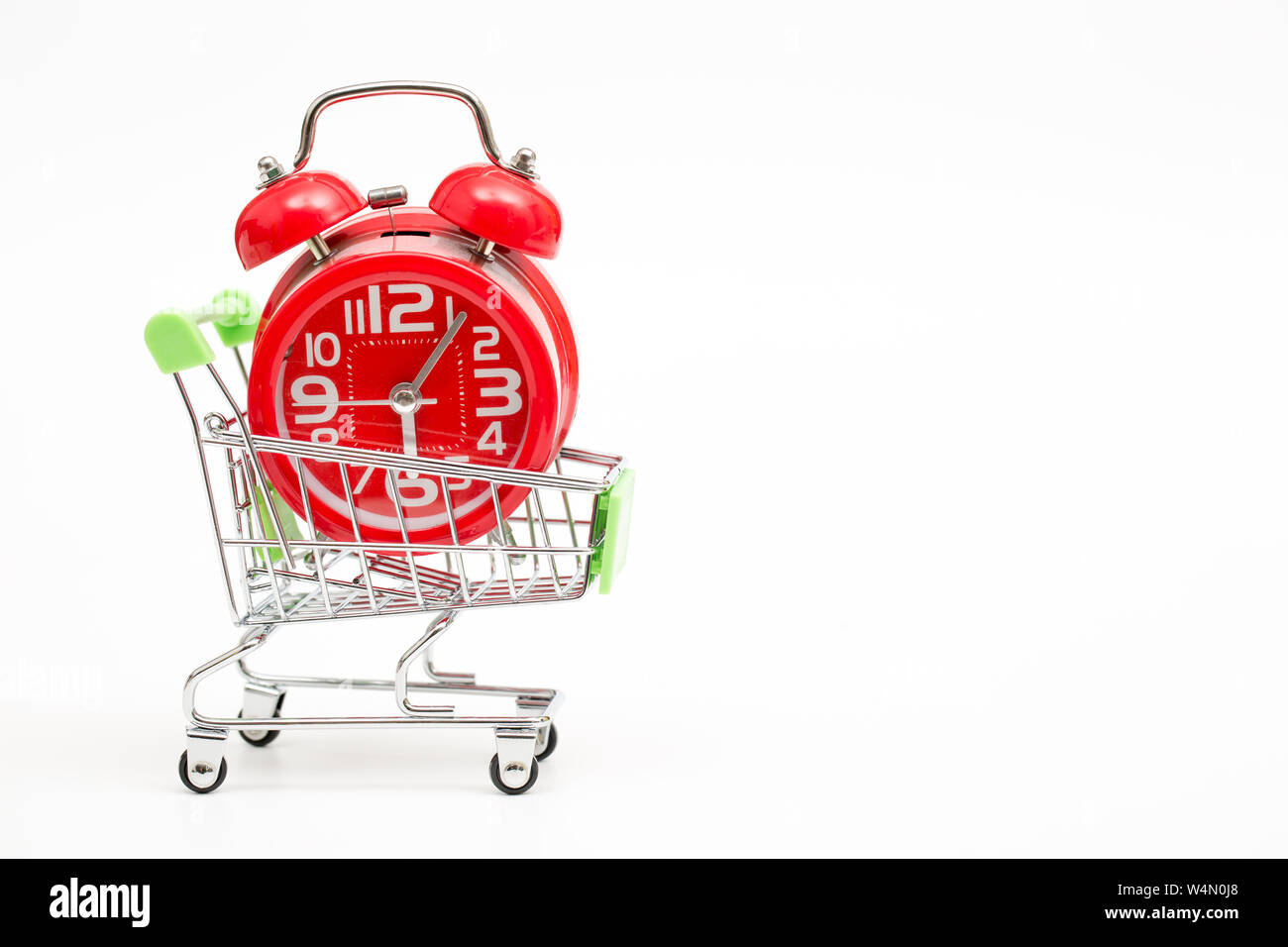 alarm clock on mini cart on white background Stock Photo - Alamy