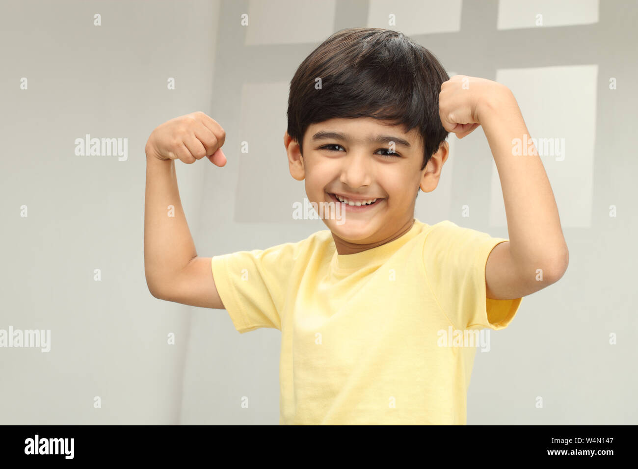 Boy showing off his muscles hi-res stock photography and images - Alamy