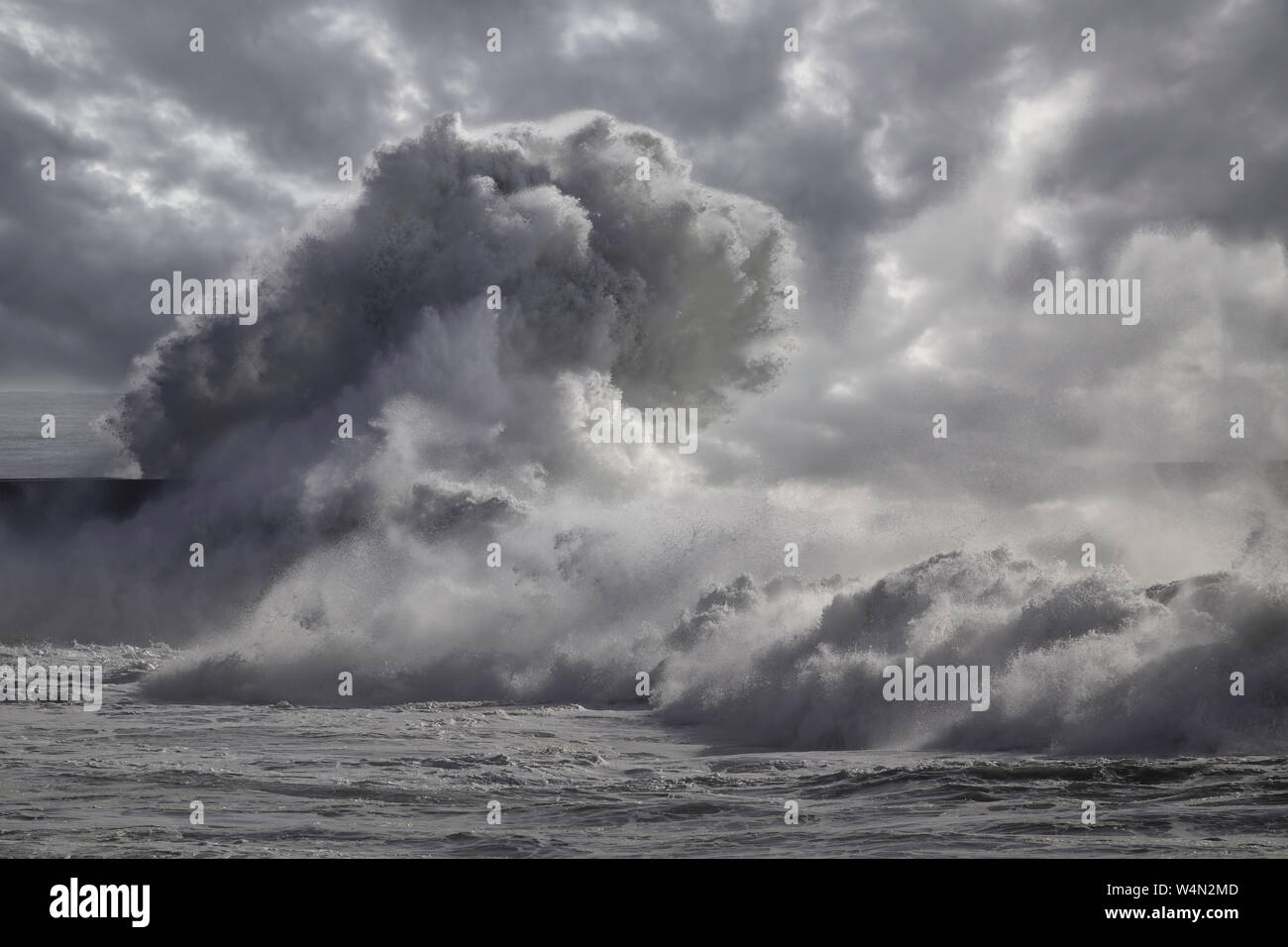 Big sea wave splash over pier. Enhanced sky Stock Photo - Alamy