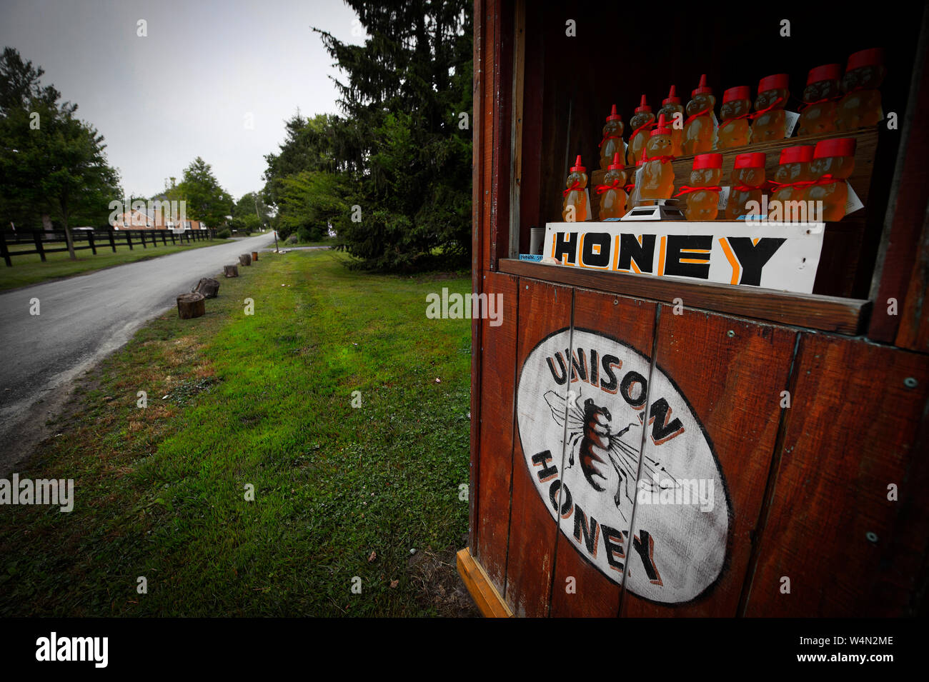 UNITED STATES - June 12, 2019: A honor system honey stand waits for ...
