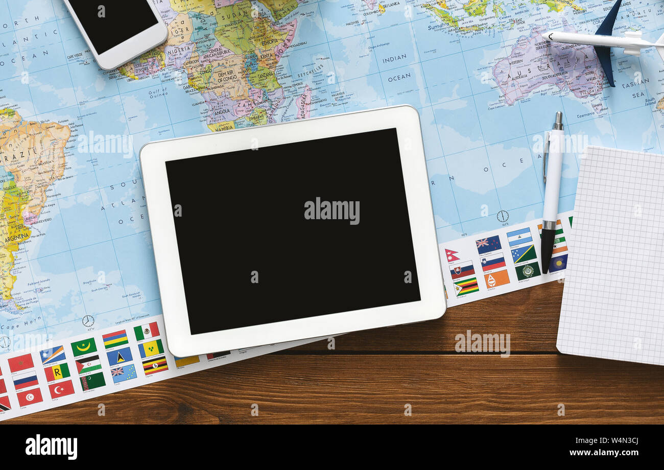 Tablet with blank screen laying on world map Stock Photo - Alamy