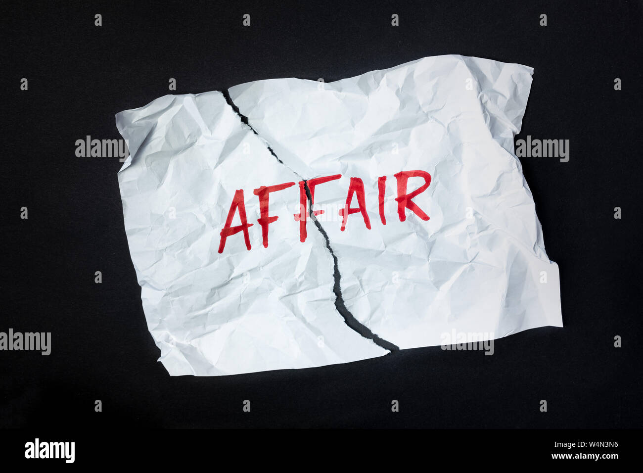 Word "affair" handwritten on crumpled paper, top view. Sign, concept of ...