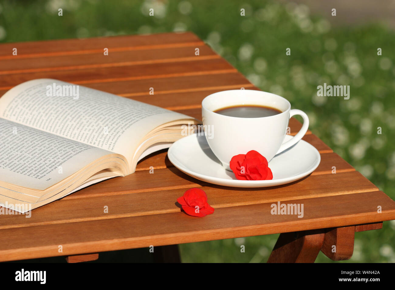 Coffee and book in the garden Stock Photo - Alamy