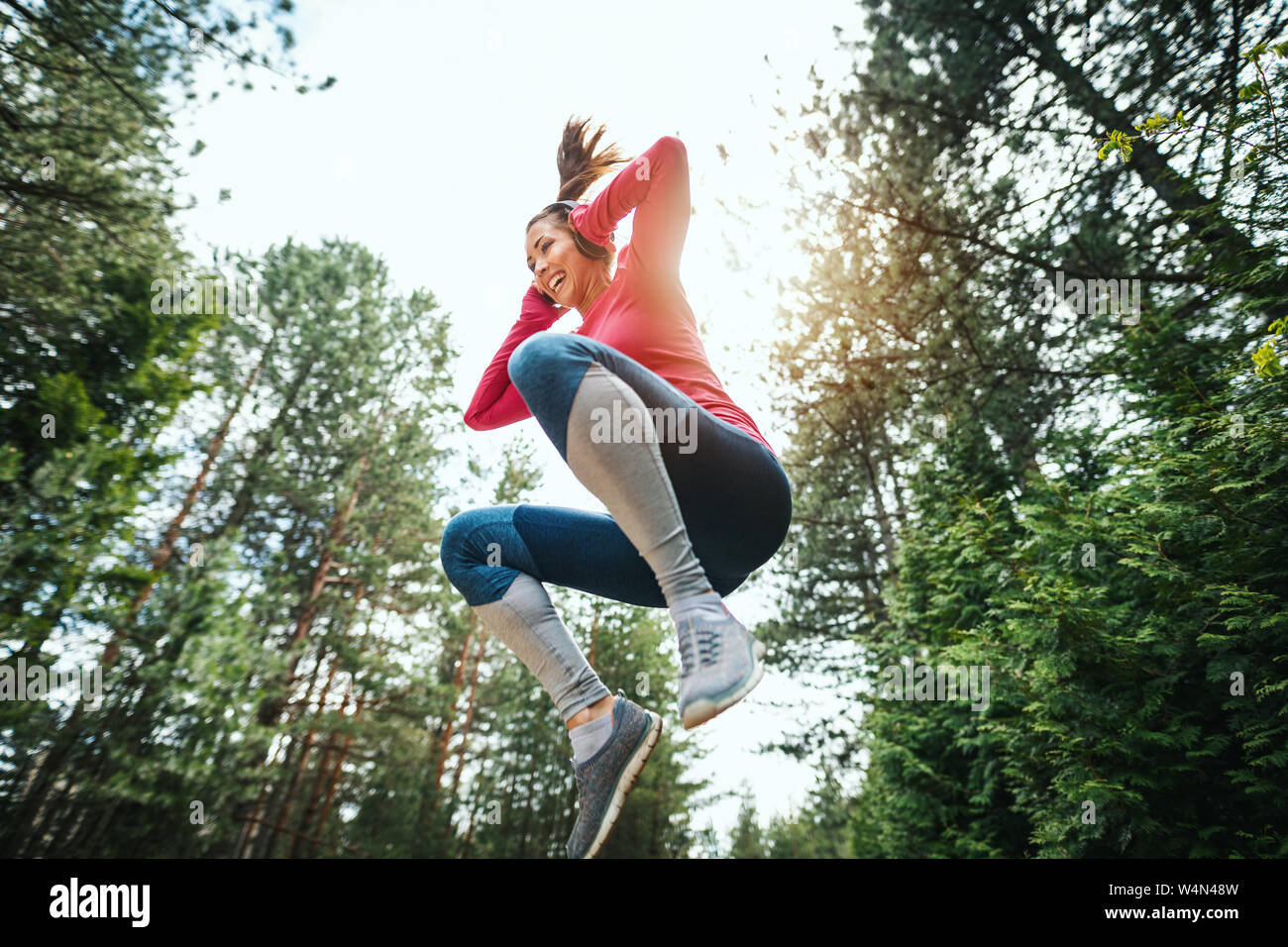 Beautiful woman jumping in forest hi-res stock photography and images ...