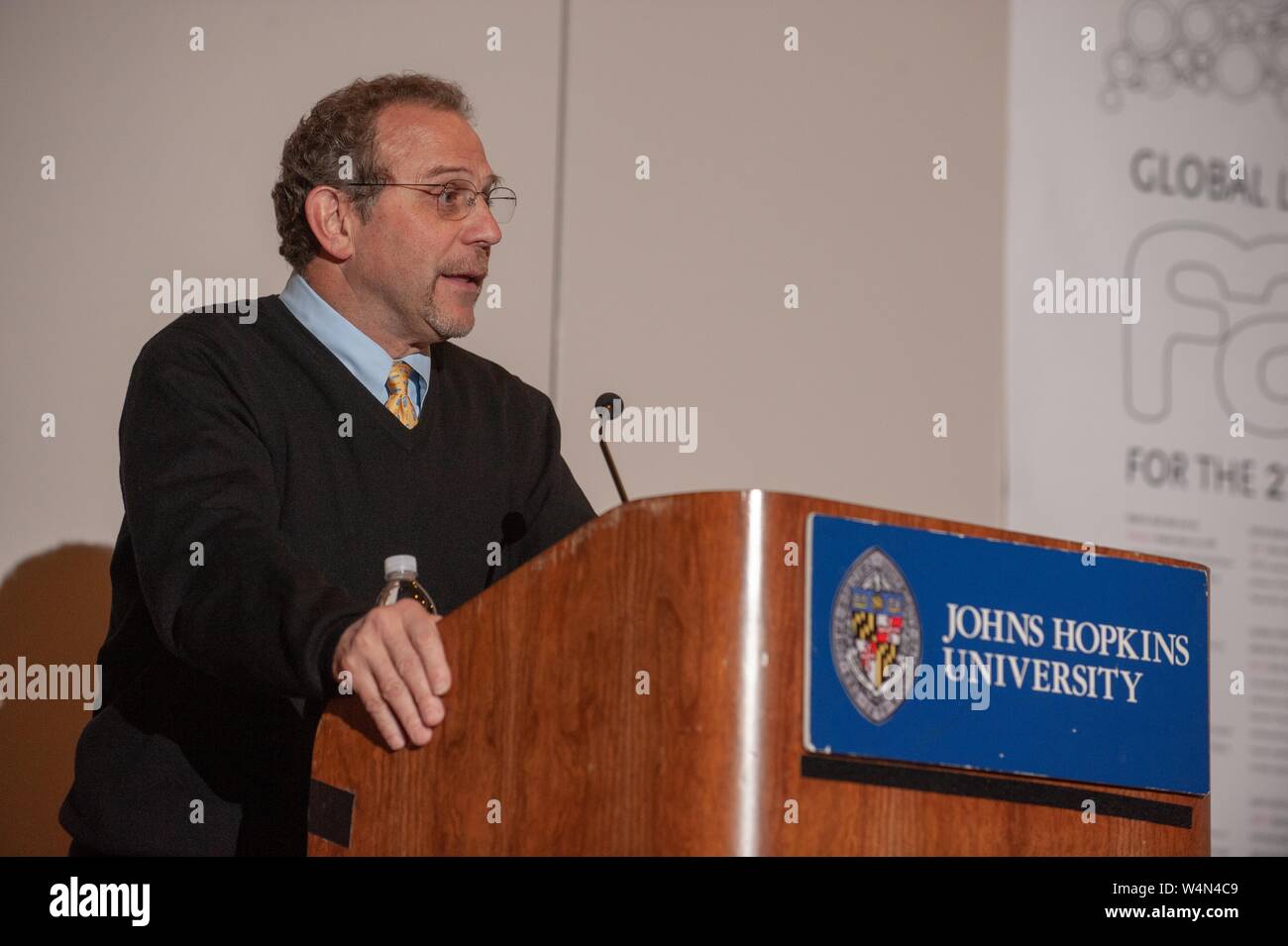 Partial profile view of economist Robert J Barbera, speaking during a ...