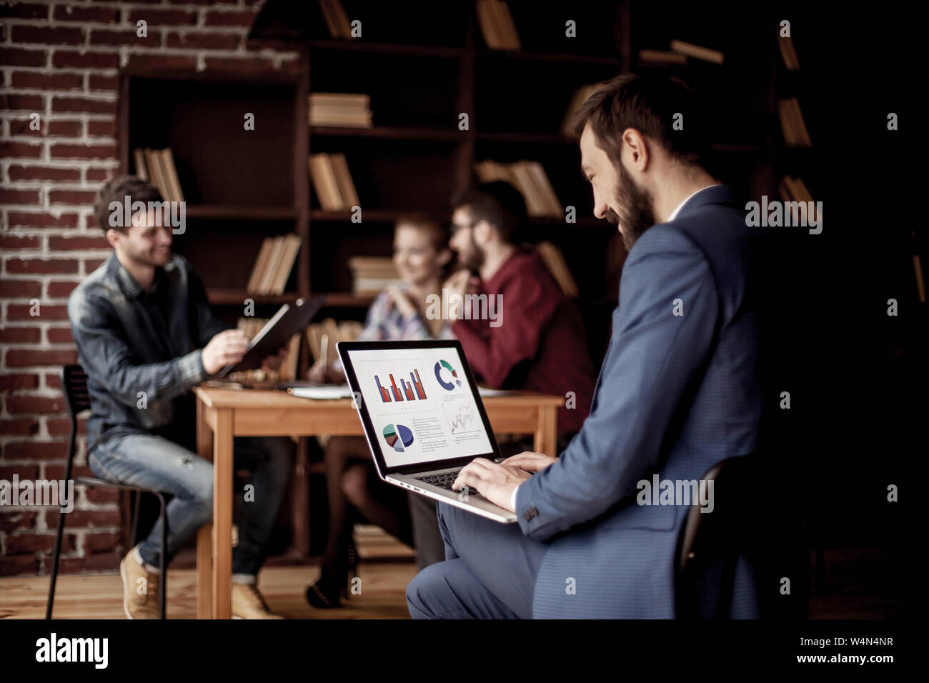 Manager Finance works with the marketing graphics on the laptop on the ...