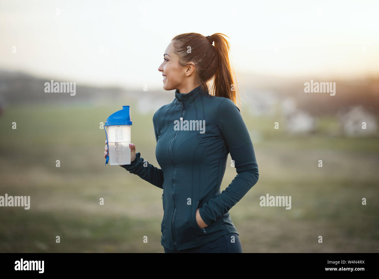 Female runner drinking water hi-res stock photography and images - Alamy