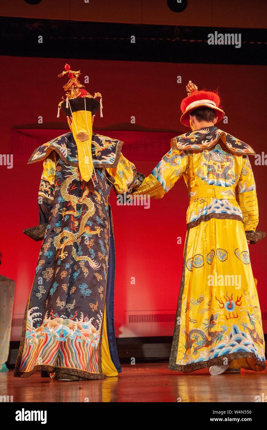 Low-angle back view of two dancers from the Colorful China Dance Group ...