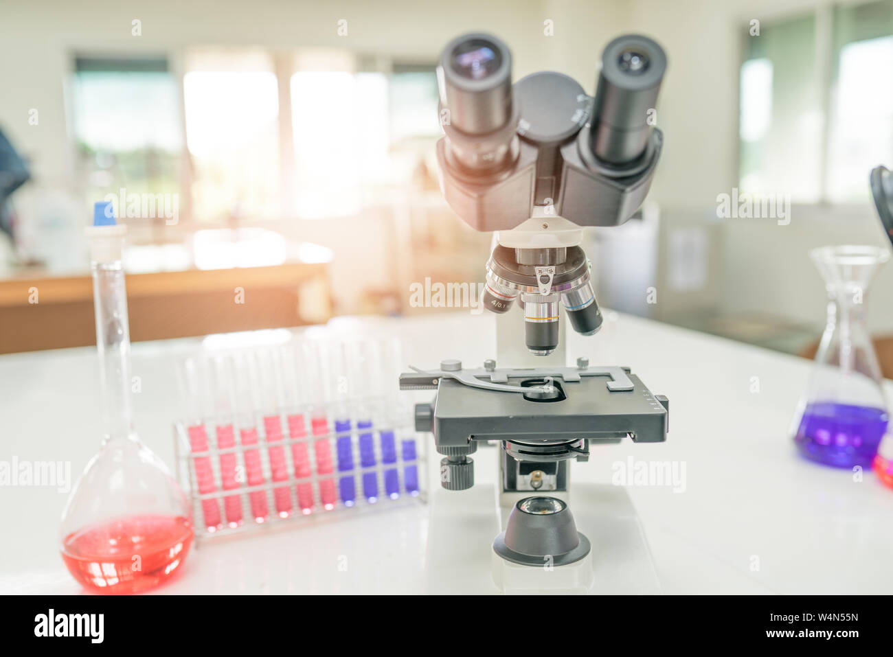 Microscope on the table in laboratory room with laboratory equipment ...