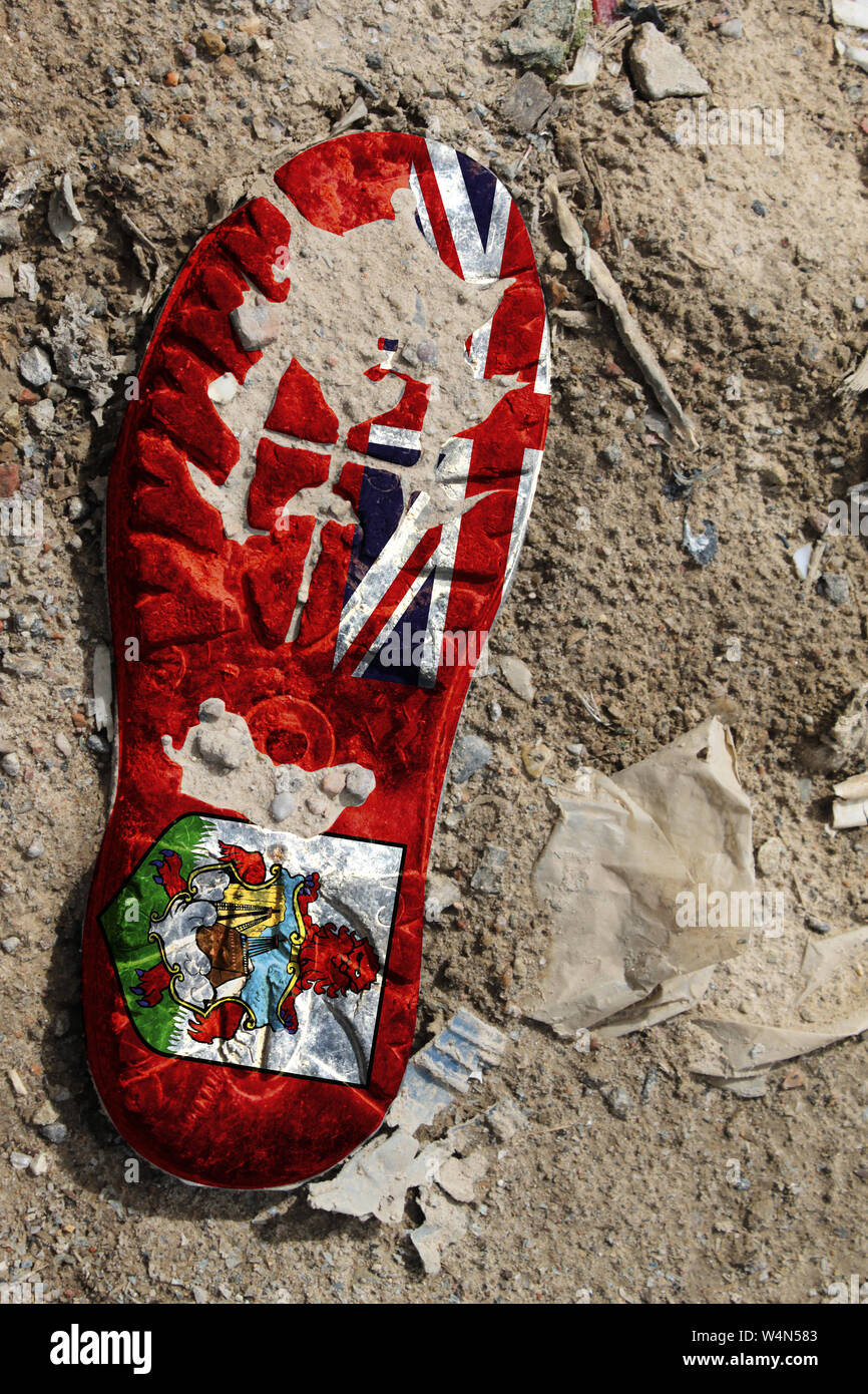 The flag of Bermuda Islands is depicted on the sole of an old boot ...