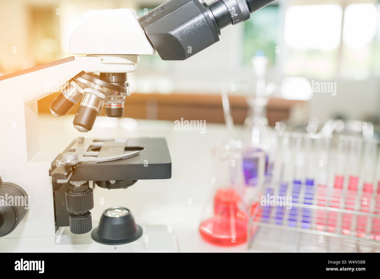 Microscope on the table in laboratory room with laboratory equipment ...