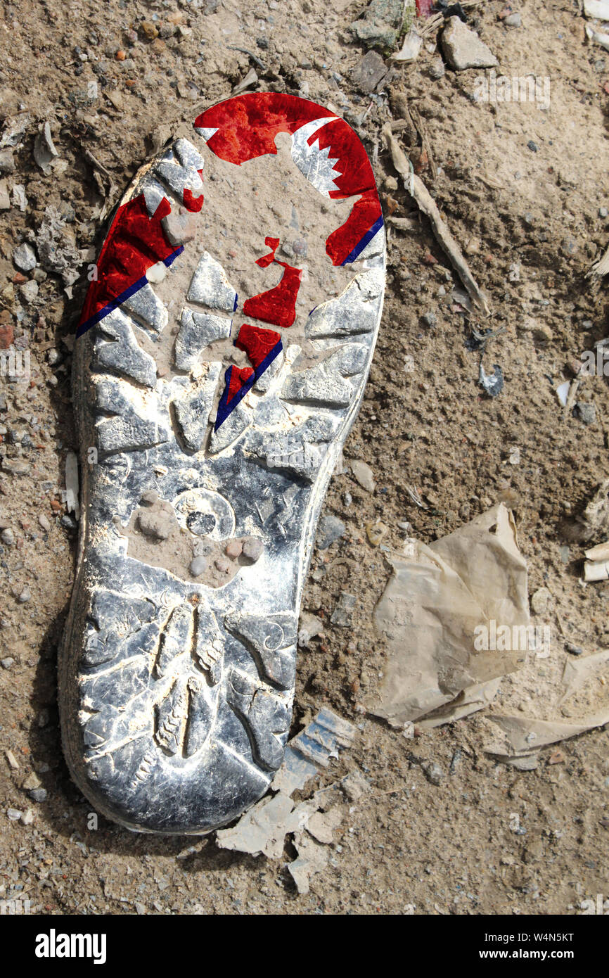 The flag of Nepal is depicted on the sole of an old boot. Ecology ...