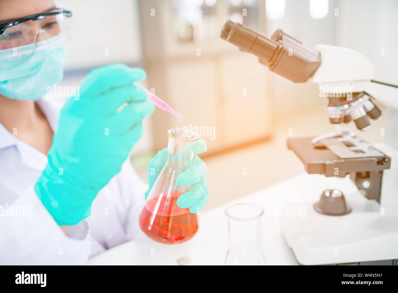 Doctor woman or chemist use dropper drop liquid chemical in to test ...