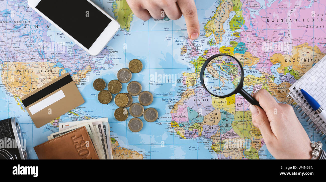 Two friends trying to find a country where to go Stock Photo - Alamy