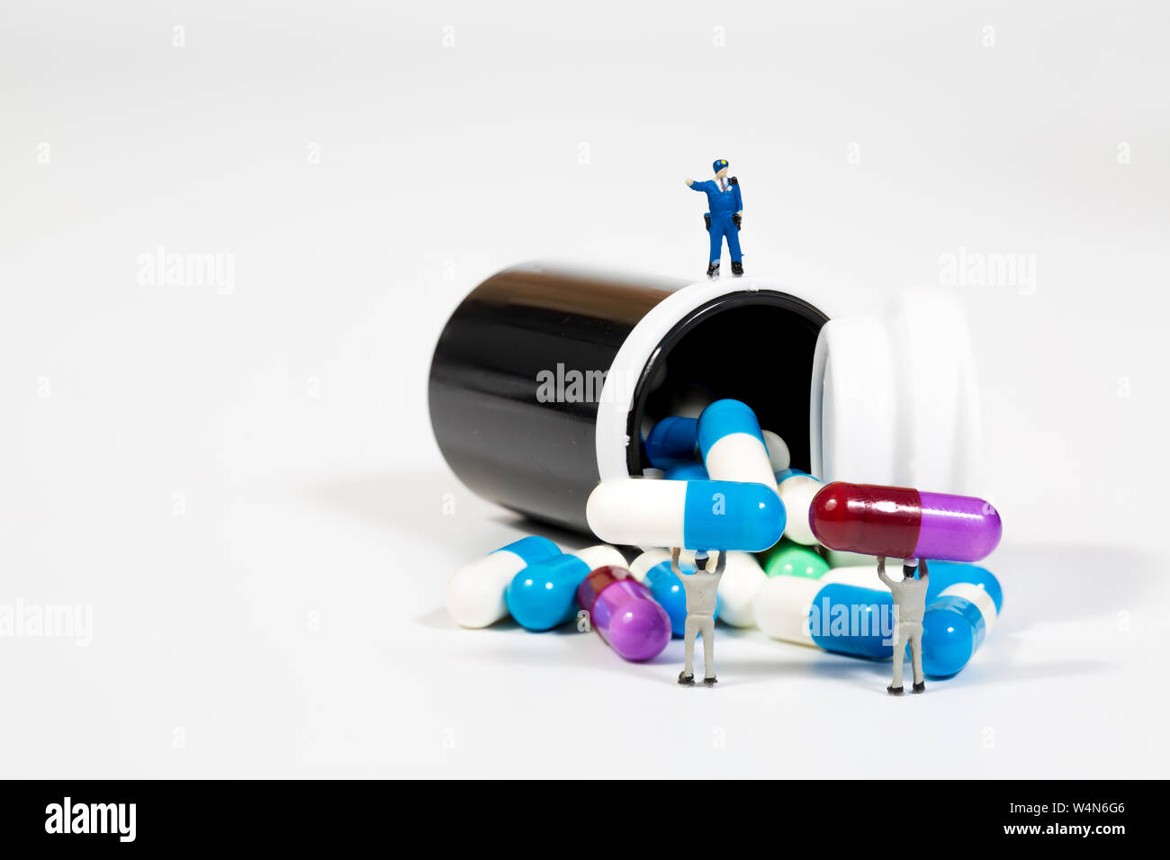 miniature people on the drugs or pils on white,medical concept Stock ...