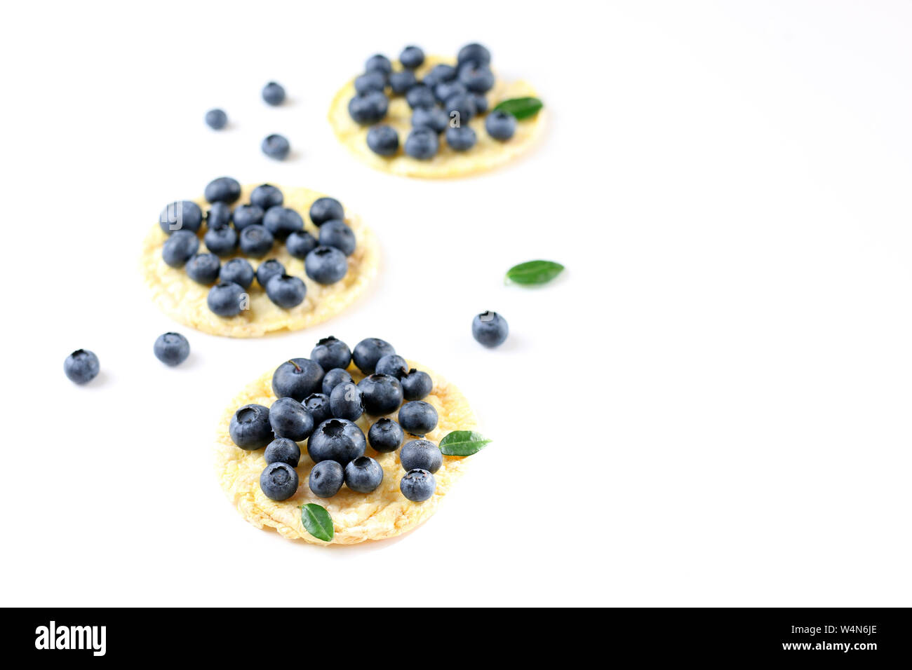 Bio organic rice cakes and fresh blueberries isolated on white ...