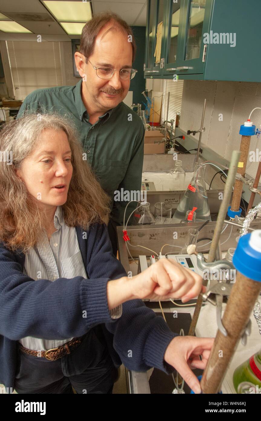 Close-up of Edward Bouwer watching Lynn Roberts adjust a bolt on an ...