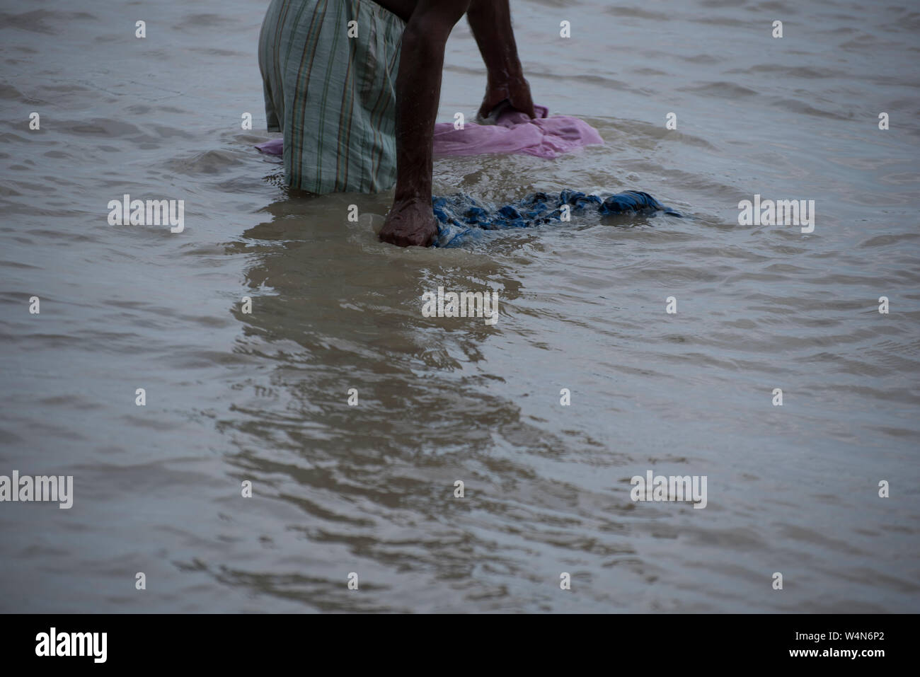 Water pollution, Man is washing cloth in the river Stock Photo - Alamy