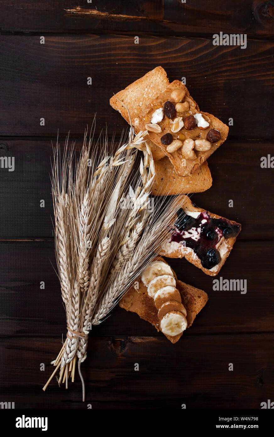 Healthy different types of morning toast with grains and wheat on ...