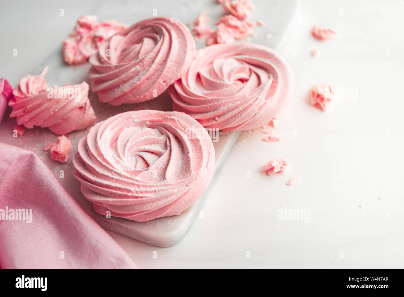 Pink meringue on a white marble tray. Copy space Stock Photo - Alamy