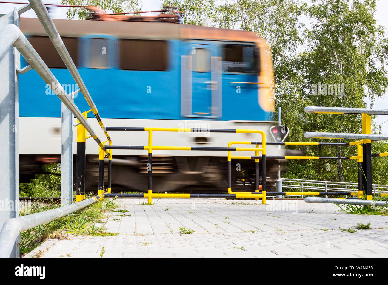InterCity train engine passing level crossing for pedestrians at Lake ...