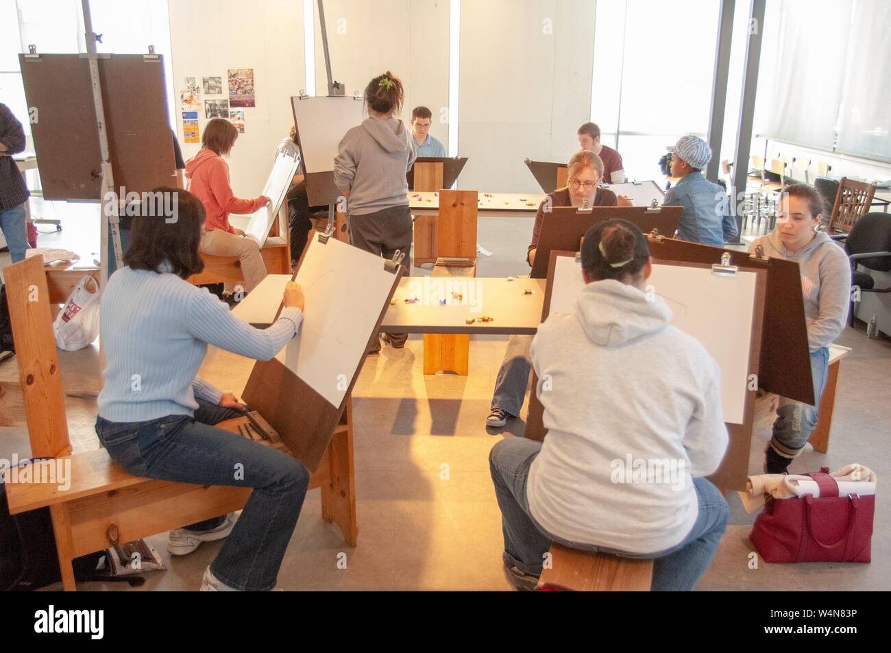 A group of artists, using standing easels and bench easels, working in ...
