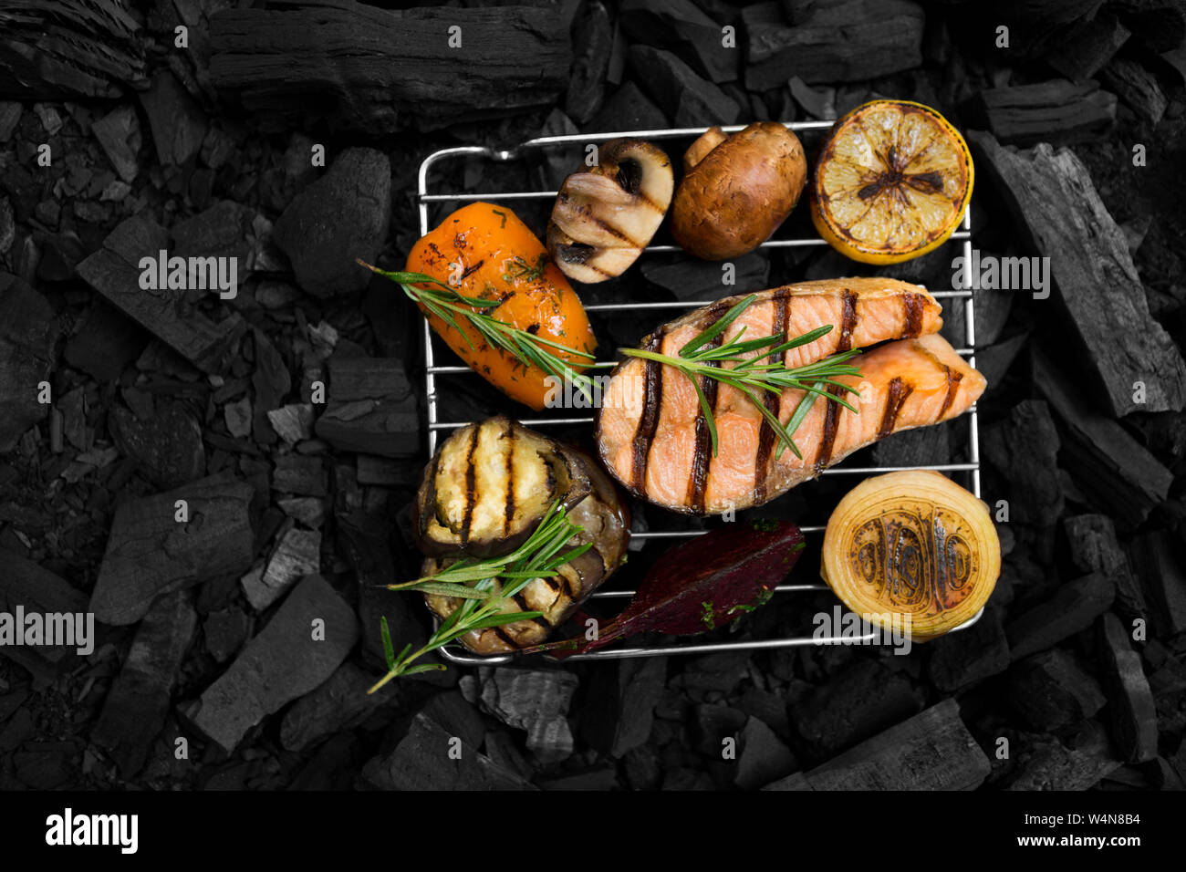 Cooked vegetables and fish on grill grate waiting for eating Stock ...