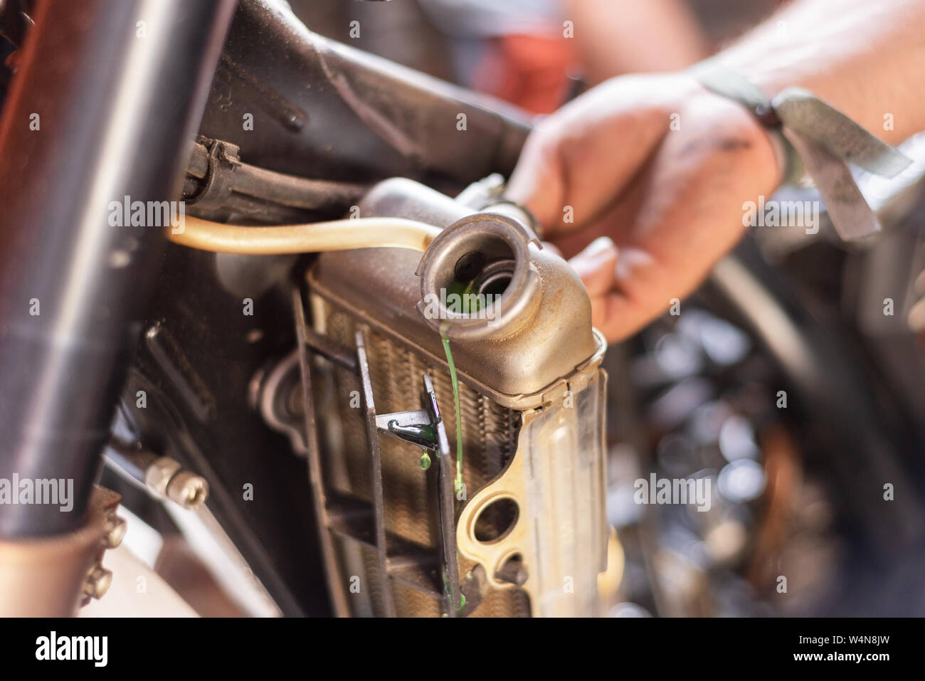Motorbike mechanic, replacing the cooling radiator. Replacement or ...